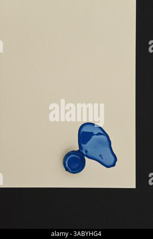 a large sheet of watercolor paper and a drop of blue pain Stock Photo ...