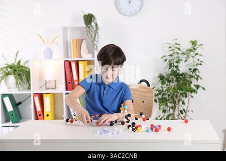 Boy making DNA structure model at desk indoors Stock Photo - Alamy