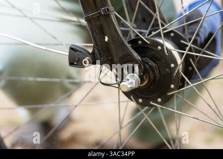 Woman wearing a gloves preparing for the bike ride in the park Stock Photo - Alamy