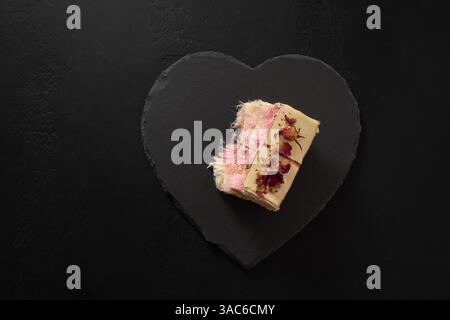 Chocolate and heart shaped sweets. Trendy pink feathers and purple ...