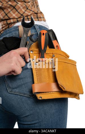 Detailed mechanic hand holding wrench fixing car suspension in garage ...