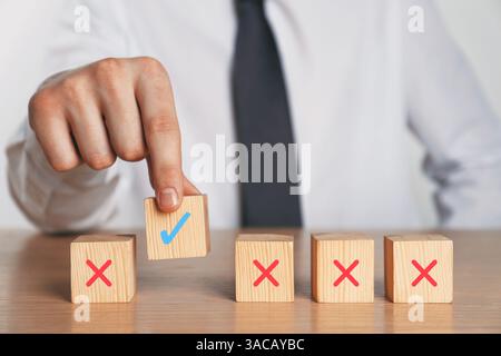 Man hand choosing red block among wooden closeup Stock Photo - Alamy