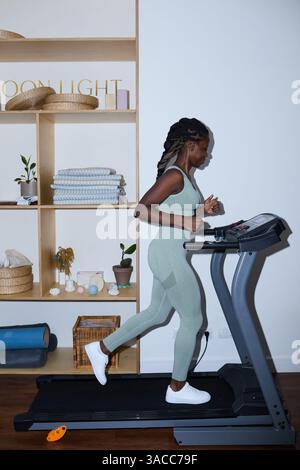 Interior of living room with modern treadmill near window Stock Photo ...