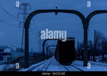 Historic catenary arches over train tracks at dusk Stock Photo - Alamy