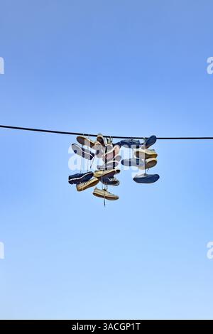 Shoes and sneakers hanging from a line in New York Stock Photo - Alamy