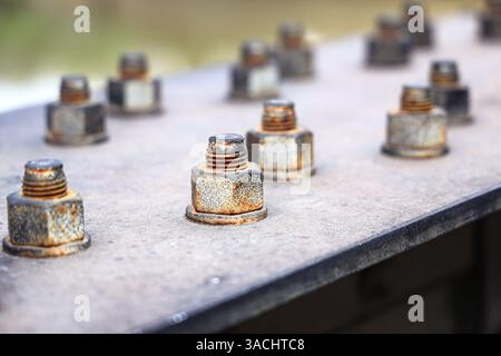 Metal supports Bolts, nuts, threaded on beams of the Steel Construction ...
