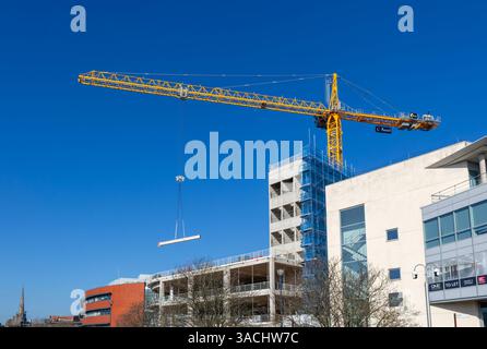 A saddle jib crane, flat-top tower crane, at building construction ...