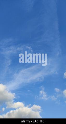 White summer clouds drifting across a vivid blue sky background Stock ...
