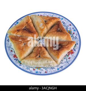 Triangular fried pies with chicken meat and onions isolate on a white ...