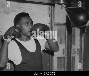 American Negero boxer Joe Brown punches the bag at Bill McConnell's gym ...