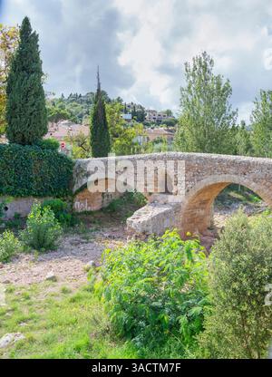 Ancient double arch stone Roman bridge (Ponte dei Salti) over the clear ...