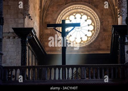 Sun shining through a round window at the crucified Christ in an medieval church, Europe Stock ...