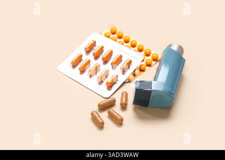Asthma inhaler and pills on beige background Stock Photo - Alamy