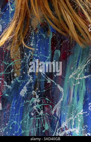 A model poses gracefully, her body adorned in vibrant body paint, with ...