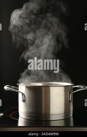 steam rising from saucepan closeup, wide photo Stock Photo - Alamy