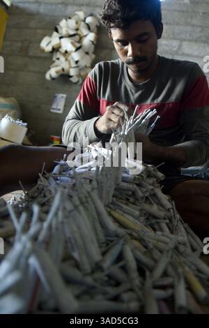 Kimbulapitiya. 4th Apr, 2025. A worker makes firecrackers at a ...
