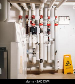Boiler room of an apartment building with pipes and metering devices. A ...