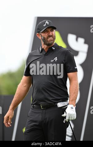 Dustin Johnson watches his shot on the driving range during a practice ...