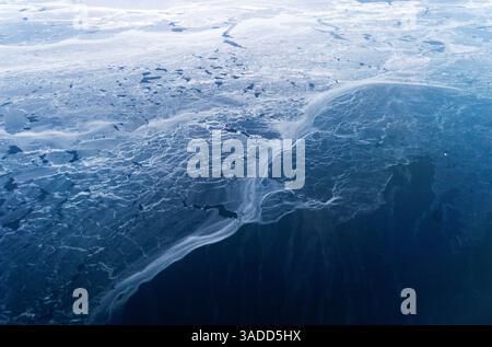 Cracked patterns of frozen river water surface, macro view Stock Photo ...