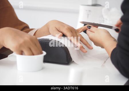 Hands during manicure care session Stock Photo - Alamy
