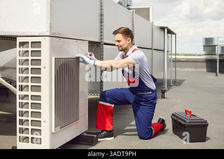 Male technician fixing air conditioner indoors Stock Photo - Alamy