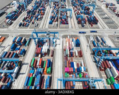 Driverless trucks transfer containers at the Dapukou container terminal ...