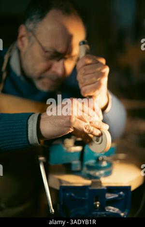 Luthier workshop with violin wooden parts and tools. Traditional ...