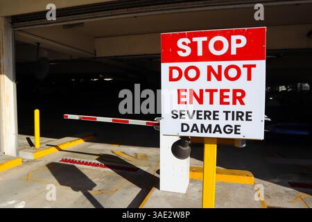 Public Garage Exit with "STOP Do Not Enter, Severe Tire Damage" Sign ...