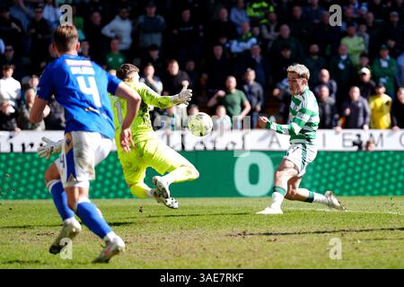 Celtic's Luke McCowan (right) has his effort on goal saved by St ...