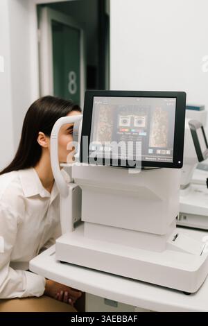 Girl undergoes an OCT eye exam using advanced optical coherence ...