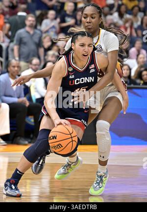 UConn guard Azzi Fudd (35) drives around South Carolina guard Bree Hall ...