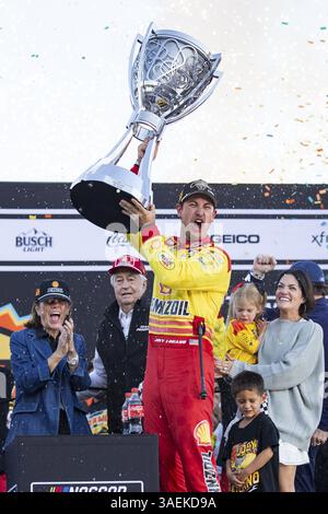Joey Logano celebrates in victory lane after winning a NASCAR Cup ...