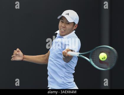 Learner Tien, of the United States plays a backhand return to Lorenzo ...