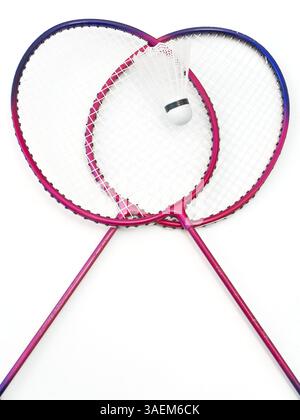 White badminton shuttlecocks and badminton rackets on dark background ...