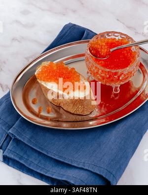 natural red salmon caviar with baguette and butter, making sandwiches ...