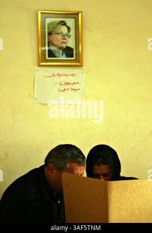 Jan 30, 2005; Arbil, Kurdistan, Iraq; A woman gives her identity card ...