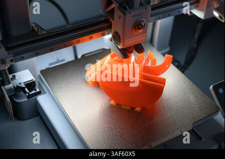 3D Printer Creating Detailed Orange Model On Platform Stock Photo - Alamy