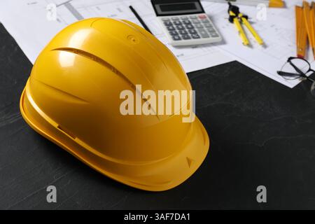 Hard hat, different engineering drawings, folding ruler and vernier ...