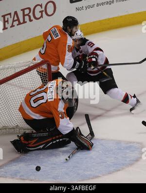 New Jersey Devils' Zach Parise, left, scores the winning goal on ...