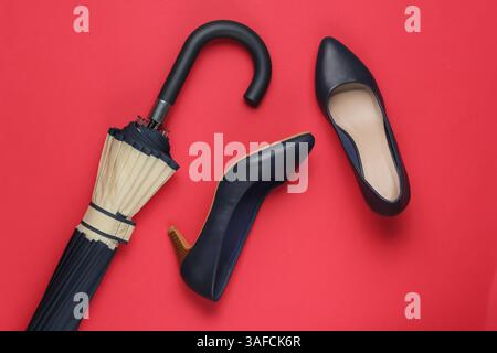 Classic high heel shoes, umbrella on red background. Minimalism fashion ...