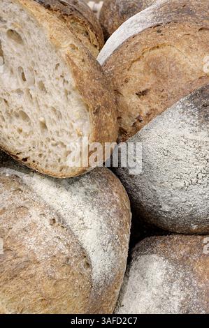 Assortment of baked artisan bread traditional on rustic retro bakery ...