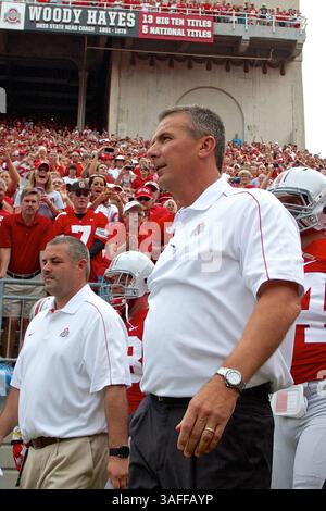 Ohio State head coach Woody Hayes pounds one of his players in the face ...