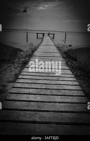 A wooden walkway leads to the beach and sea at Formby Stock Photo - Alamy