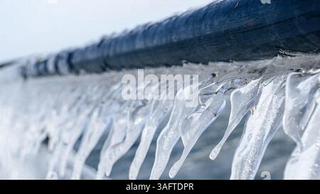 Beautiful Icicles Forming on a Metal Fence with Sunlight Creating a ...