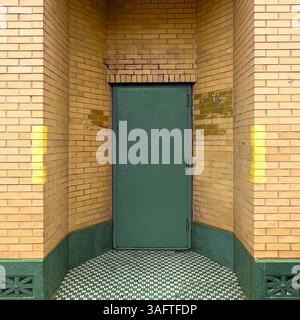 Brick industrial building utility service bay with two large brown ...