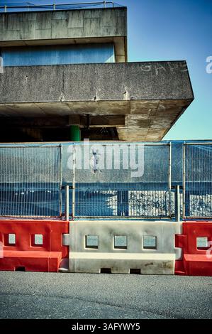 Fence and barrier infront of old concrete building set for demolition ...