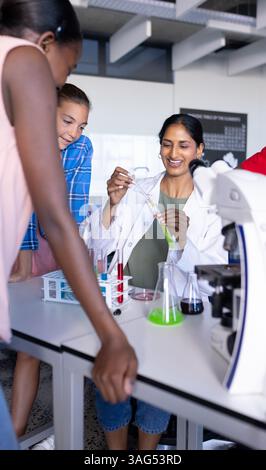 Conducting science experiment with test tubes, students in school ...