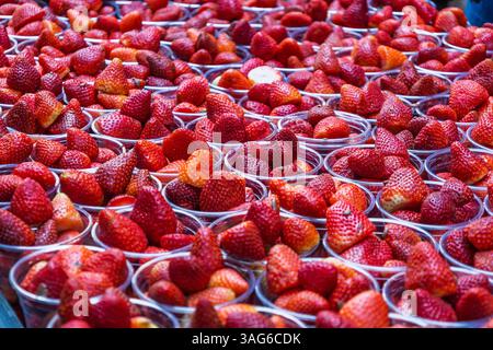 Colorful fruit cups at a street market in summer Stock Photo - Alamy