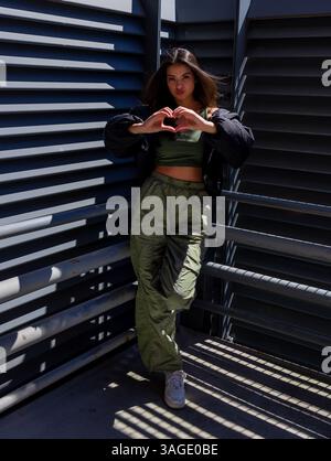 Positive woman makes like hand sign, thumbs up gesture. Happy girl ...