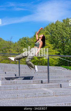 Gen Z woman taking a break from city life and relaxing in the sunlight ...